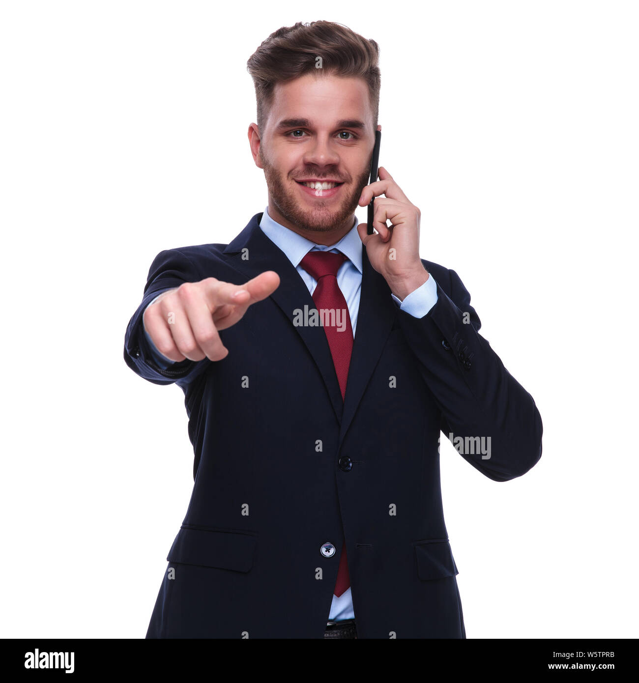 portrait of businessman talking on the phone and pointing finger while ...