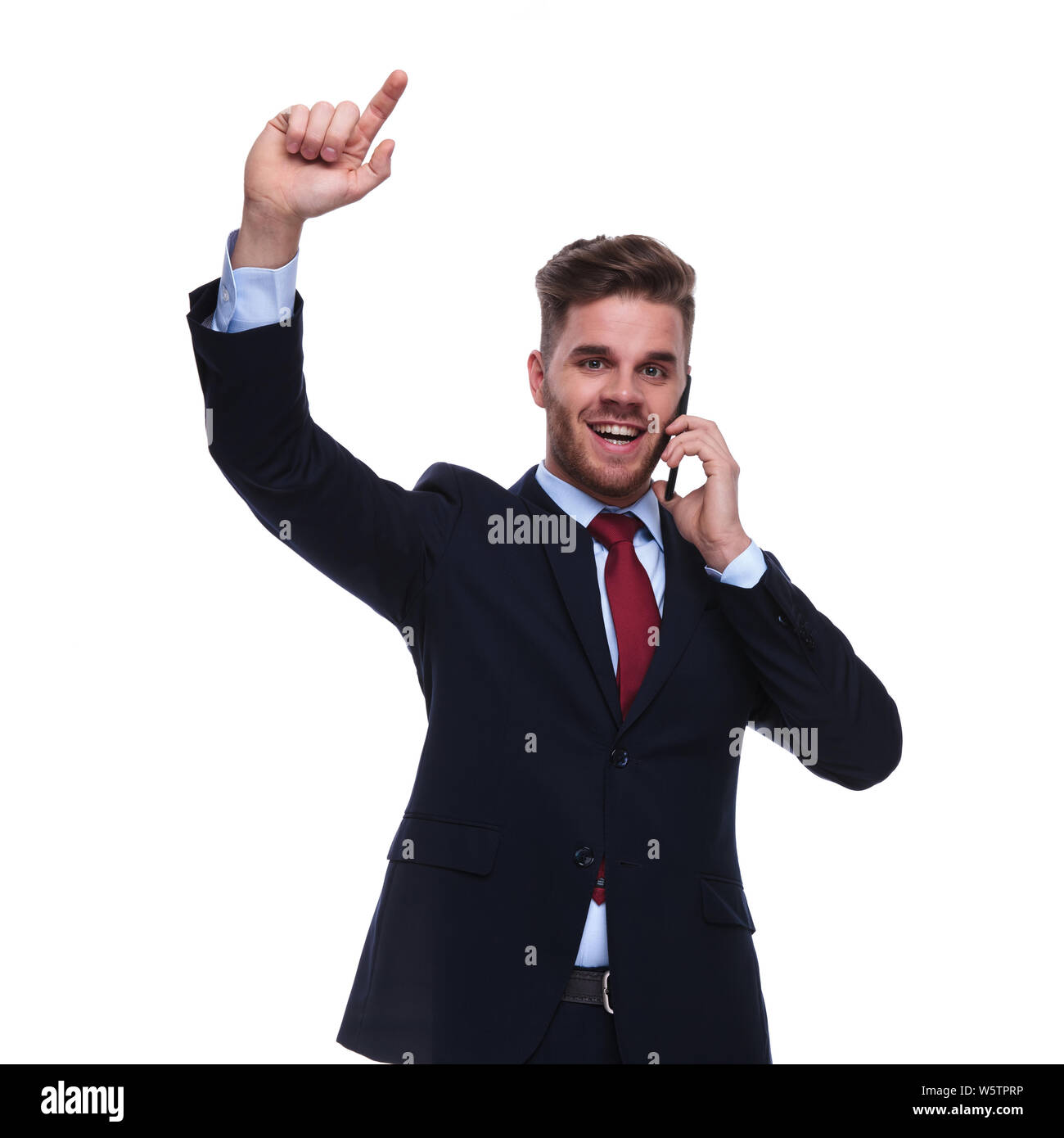 excited businessman talking on the phone is celebrating with hand in ...