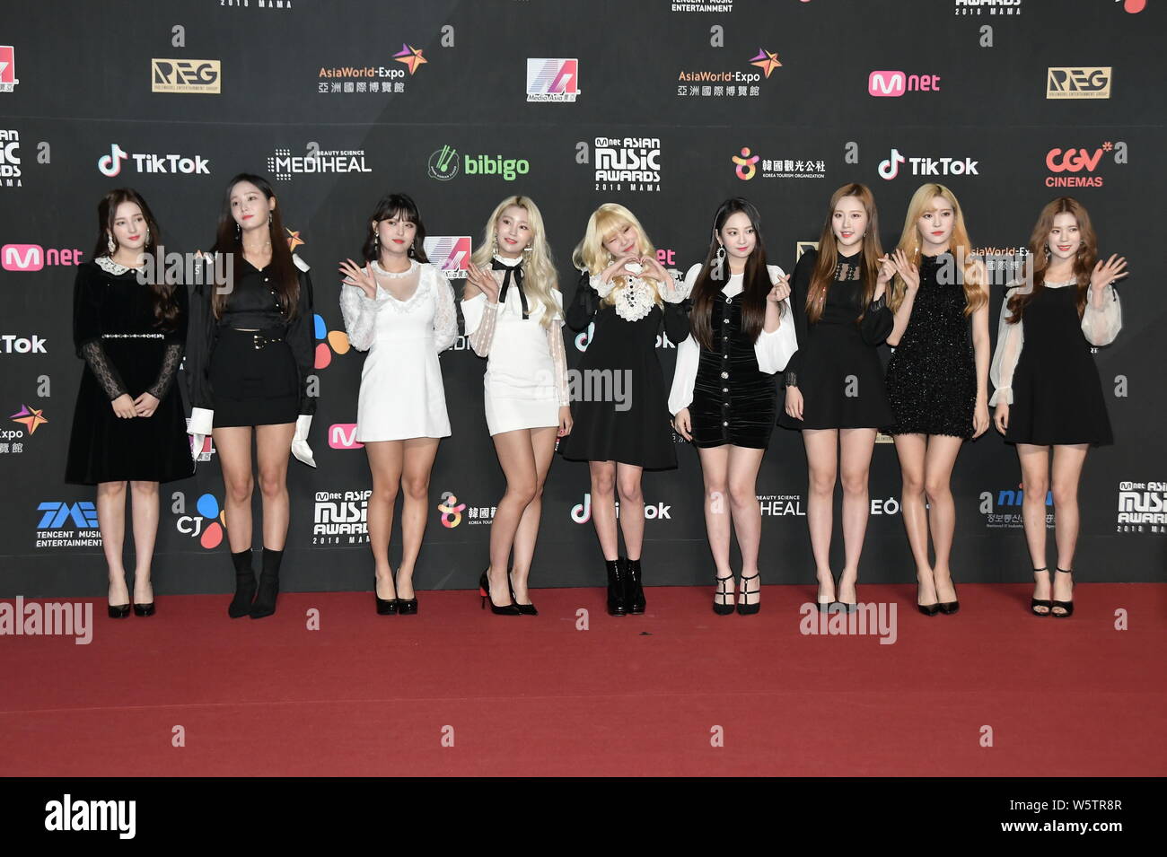 Members of South Korean girl group Momoland pose as they arrive on the ...
