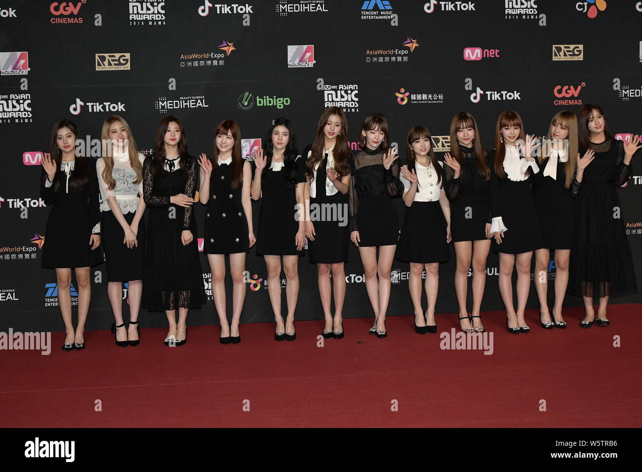 Members of South Korean girl group Izone, stylized as IZ*ONE, pose as ...