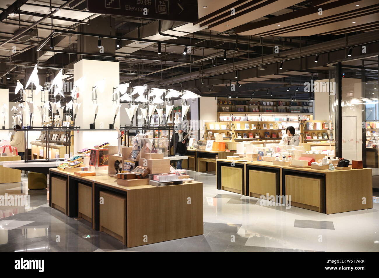 Books are placed on the four-storey-high book wall decorated with glass ...