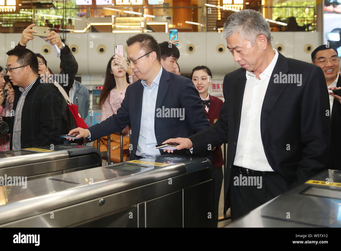 Passengers put their smartphones above turnstiles to have the QR code ...