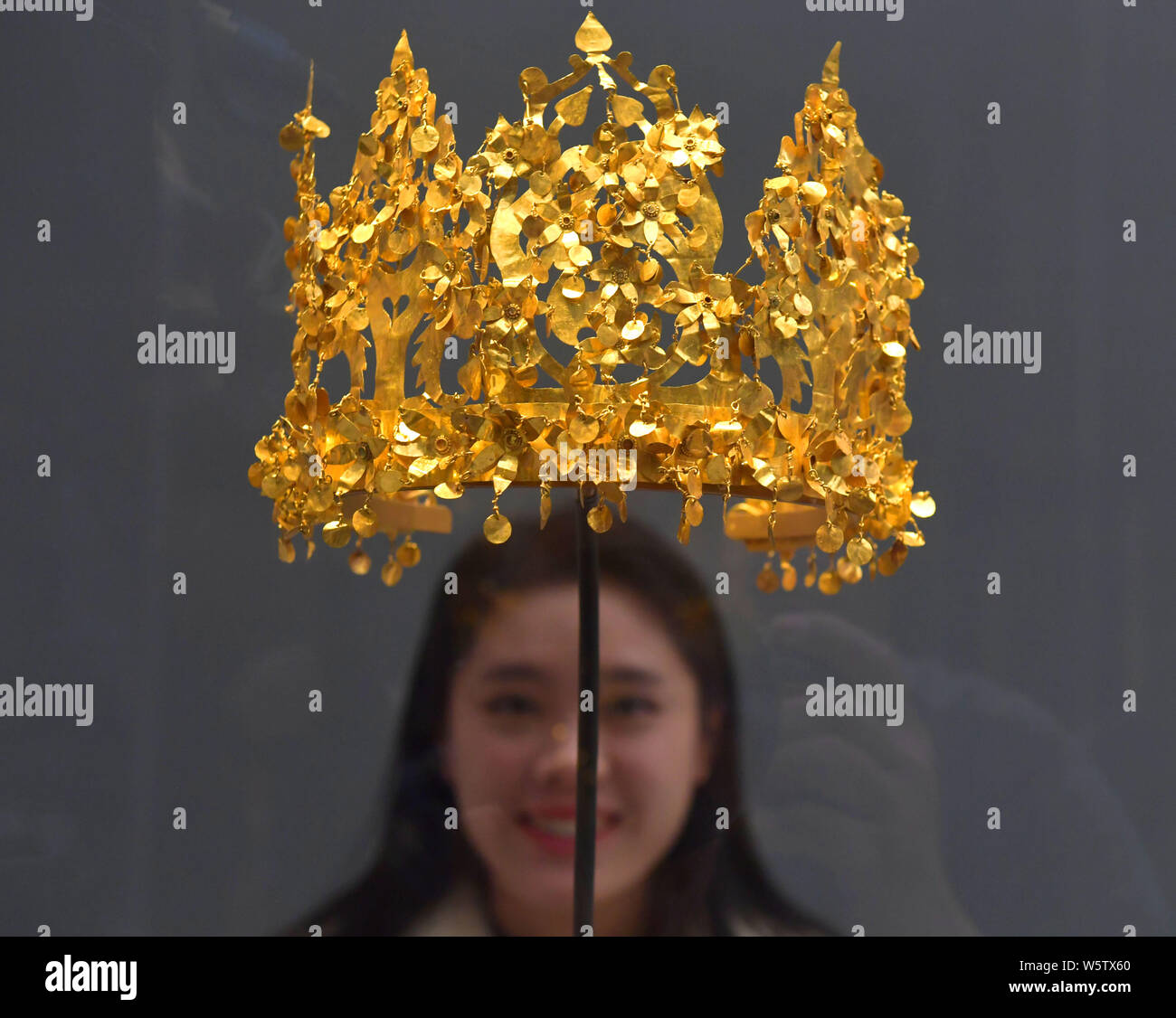 Chinese employees display an ancient headwear from Afghanistan dating ...