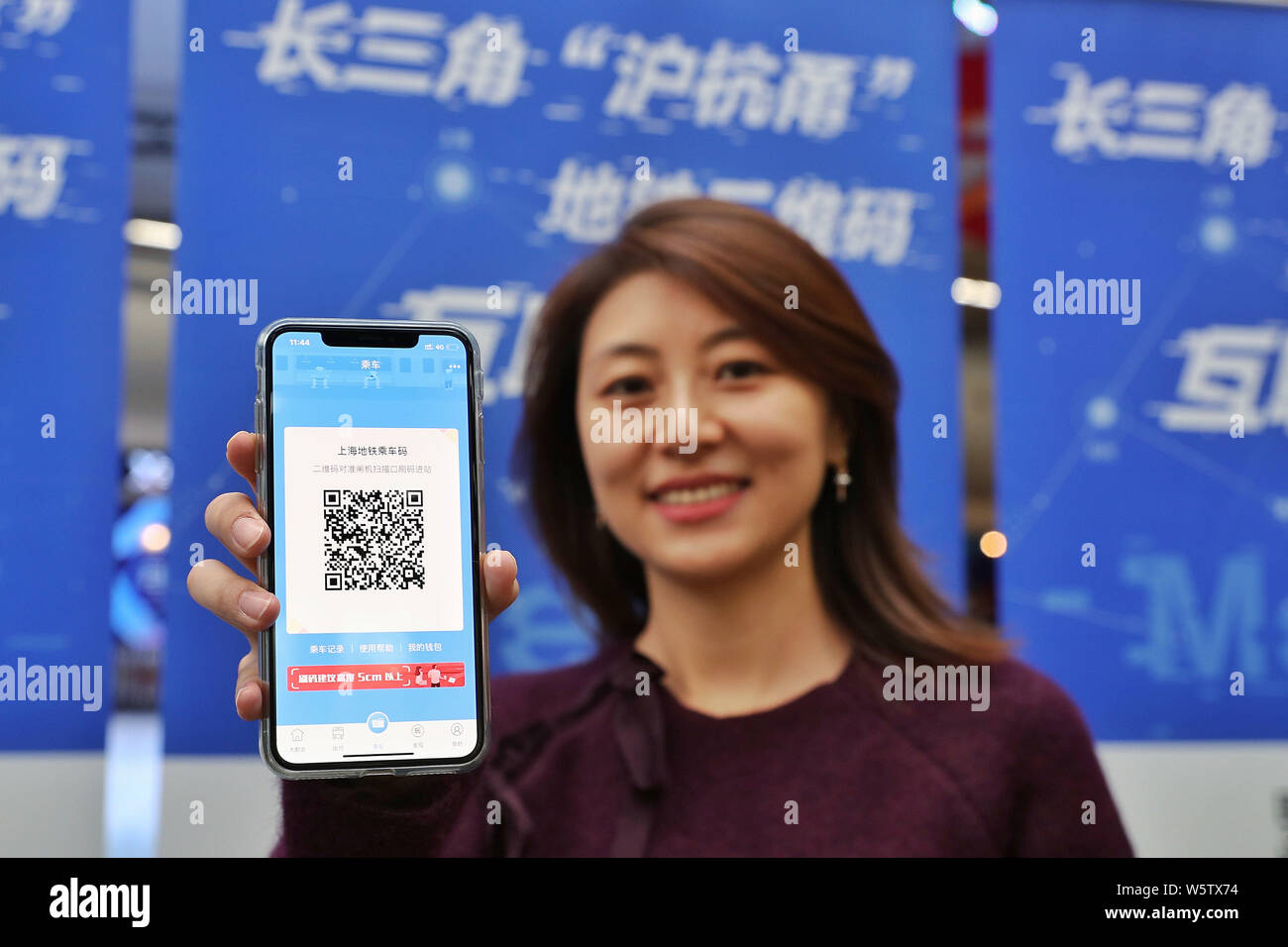 A passenger shows the QR code on the Metro Daduhui app scanned to pay ...