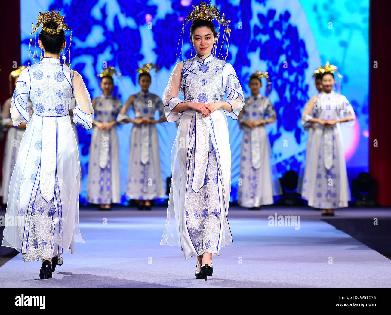 A model presents a new creation of cheongsam (qipao) made of ...