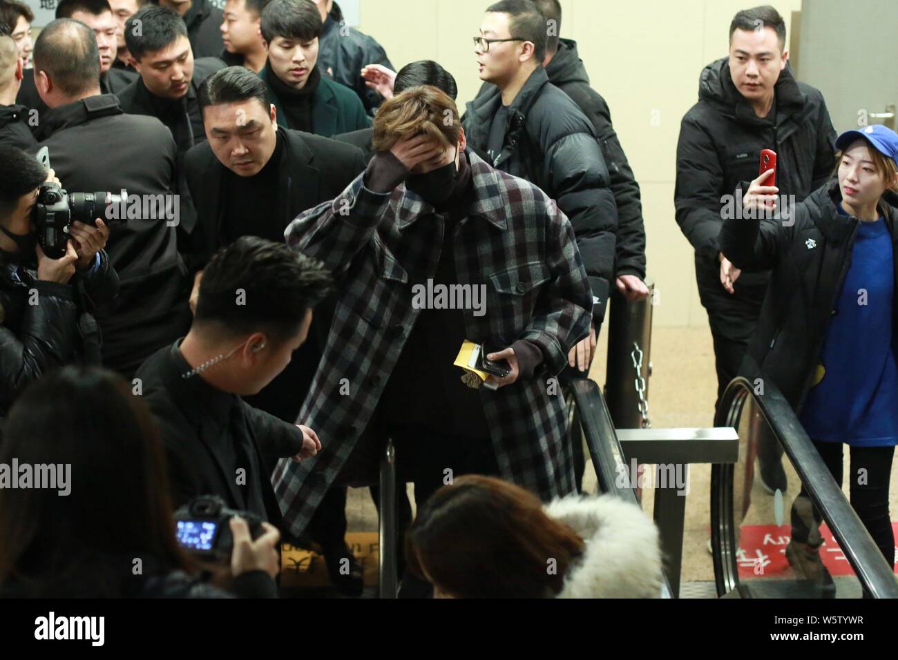 South Korean actor and model Lee Jong-suk, center, is surrounded by ...