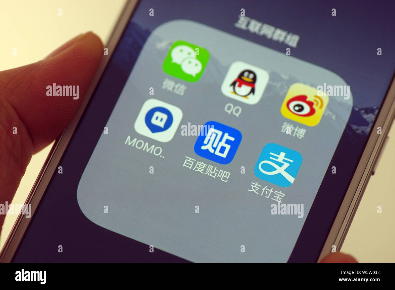 --FILE--A Chinese mobile phone user looks at the icons of Chinese ...