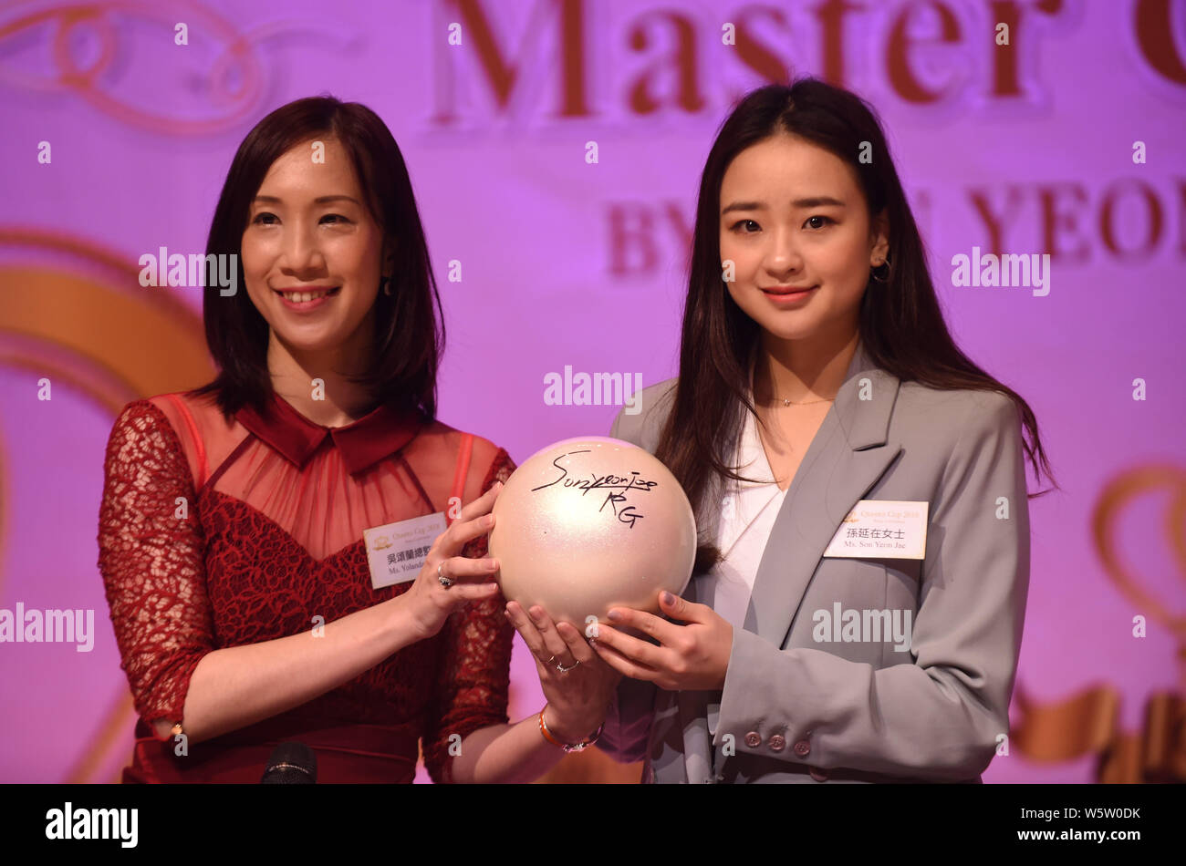 South Korean retired individual rhythmic gymnast Son Yeon-jae, right, attends a press conference ...