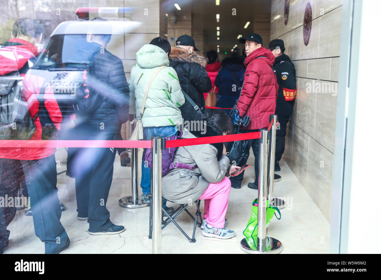 Chinese customers queue up outside the headquarters of the bike-sharing service ofo to demand an ...