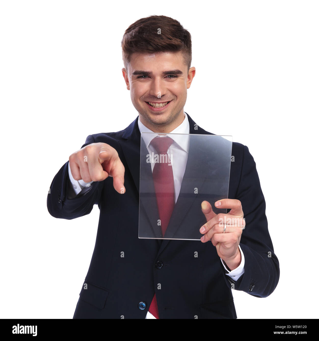 portrait of smiling businessman holding a transparent gadget pointing ...