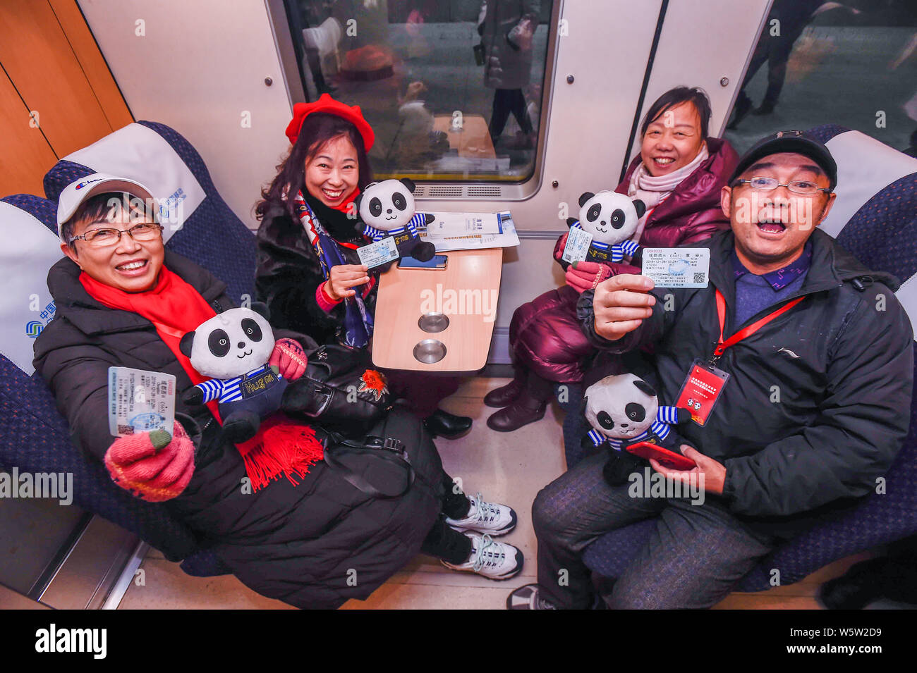 Passengers pose with giant pandas toys in a CRH (China Railway High ...