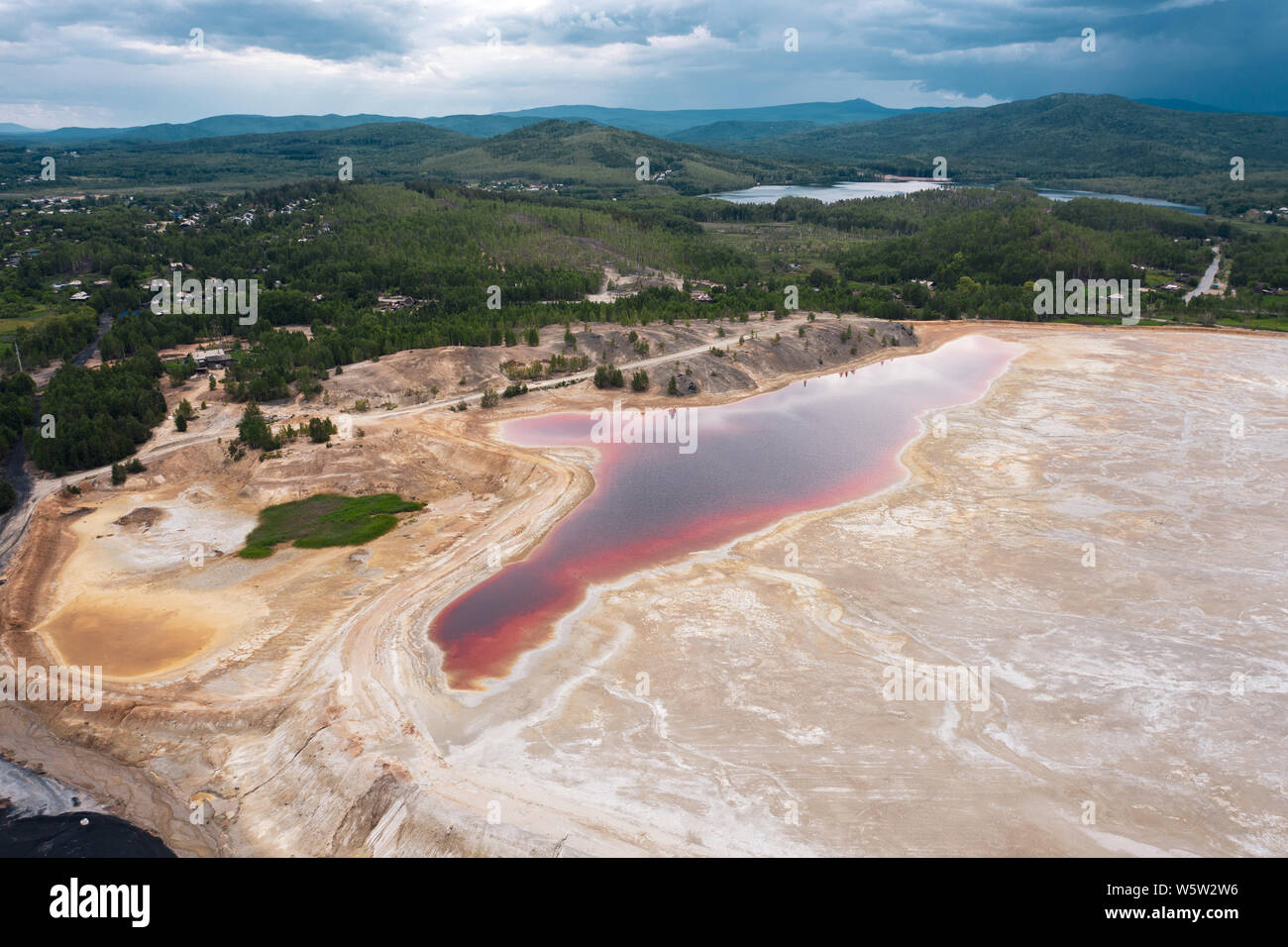 Pink colored water reservoir; copper digging production site ...