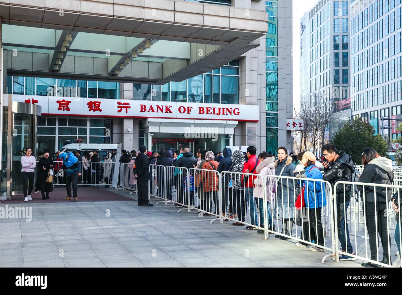 Chinese customers queue up outside the headquarters of the bike-sharing ...