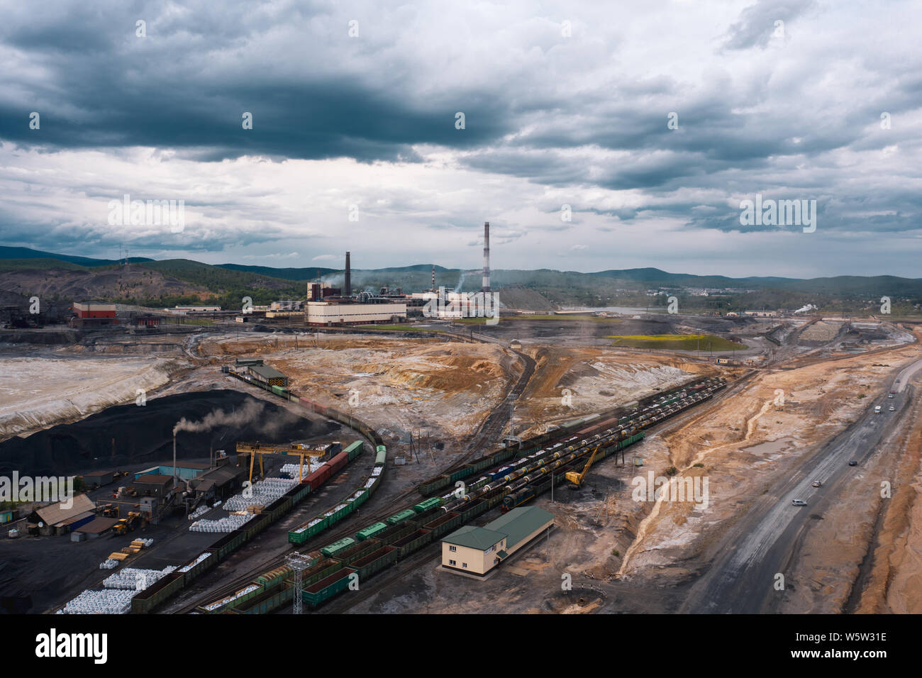 Train moving forward among the black dumps, polluted terrain, no ...