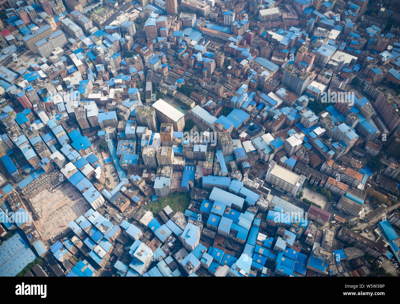 Aerial view of illegally-built blue rooftops built by apartment owners ...