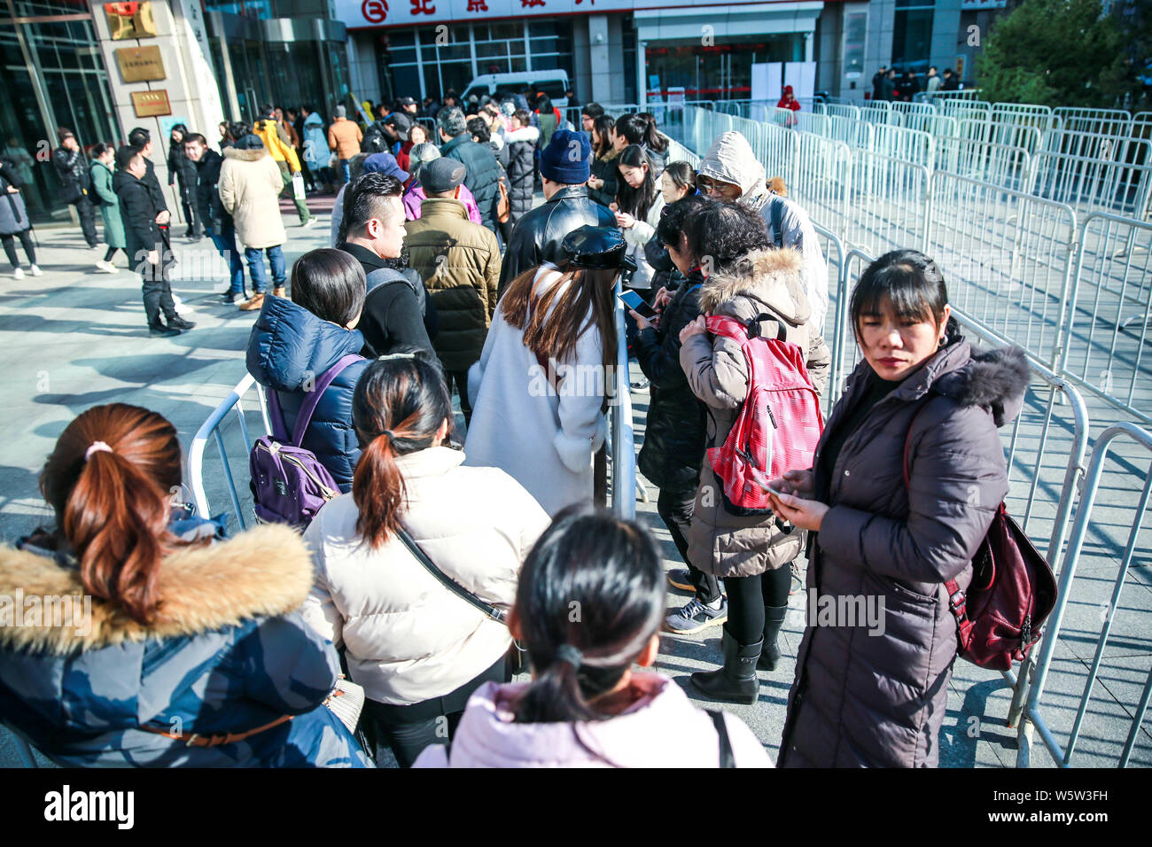 Chinese customers queue up outside the headquarters of the bike-sharing service ofo to demand an ...