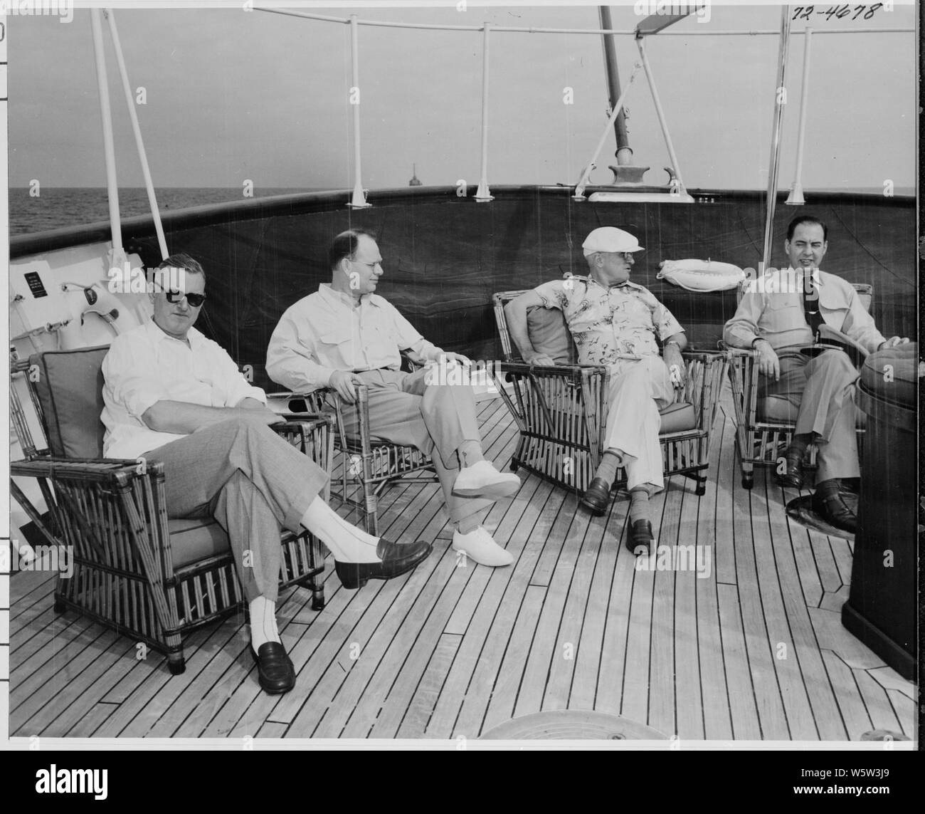 Photograph of President Truman and members of his staff relaxing on the ...