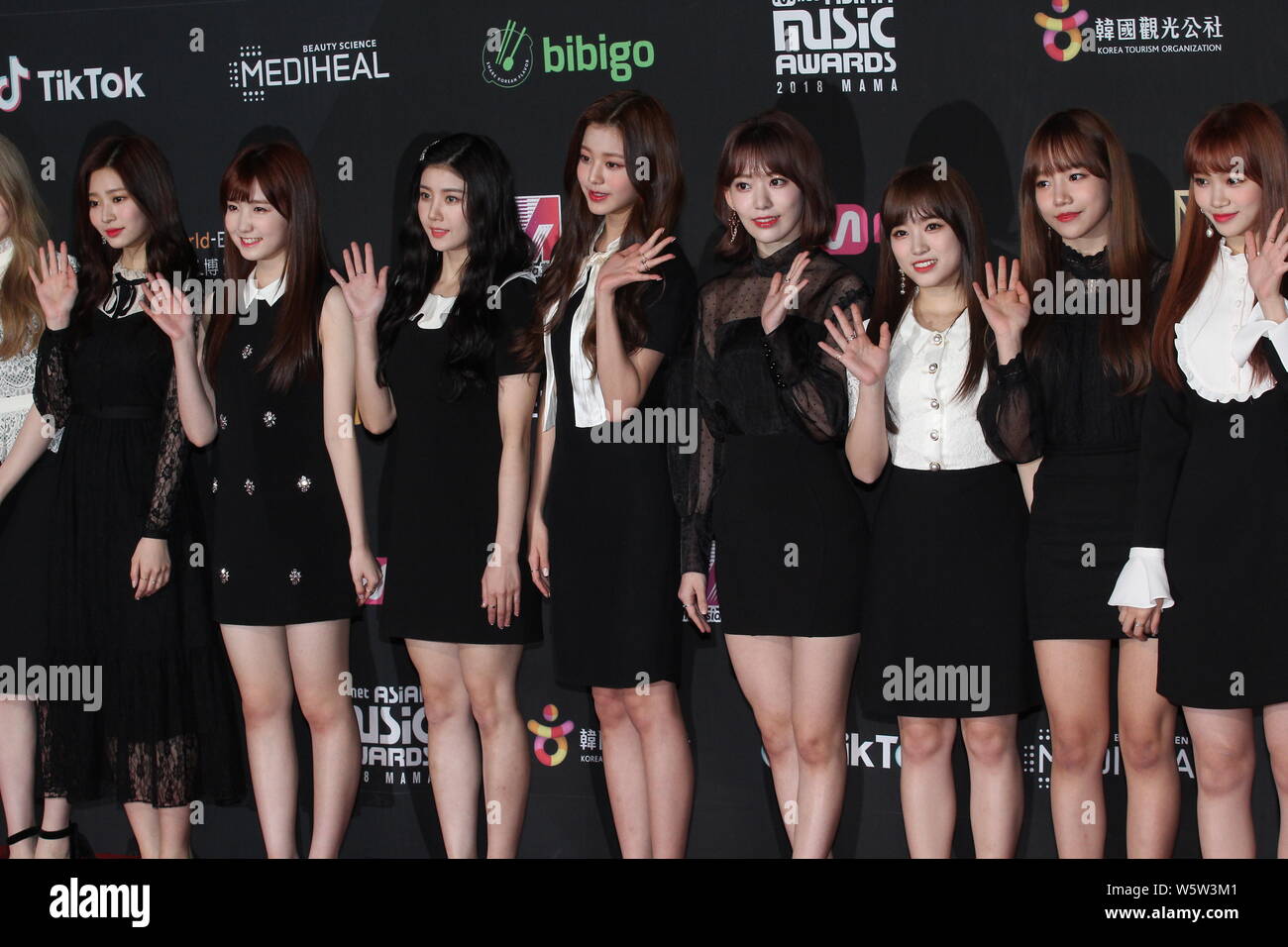 Members of South Korean girl group Izone, stylized as IZ*ONE, pose as ...