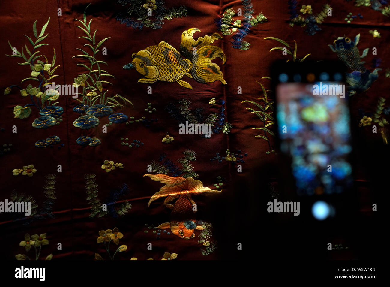 Beijing, China. 30th July, 2019. A weaving material with goldfish and ...