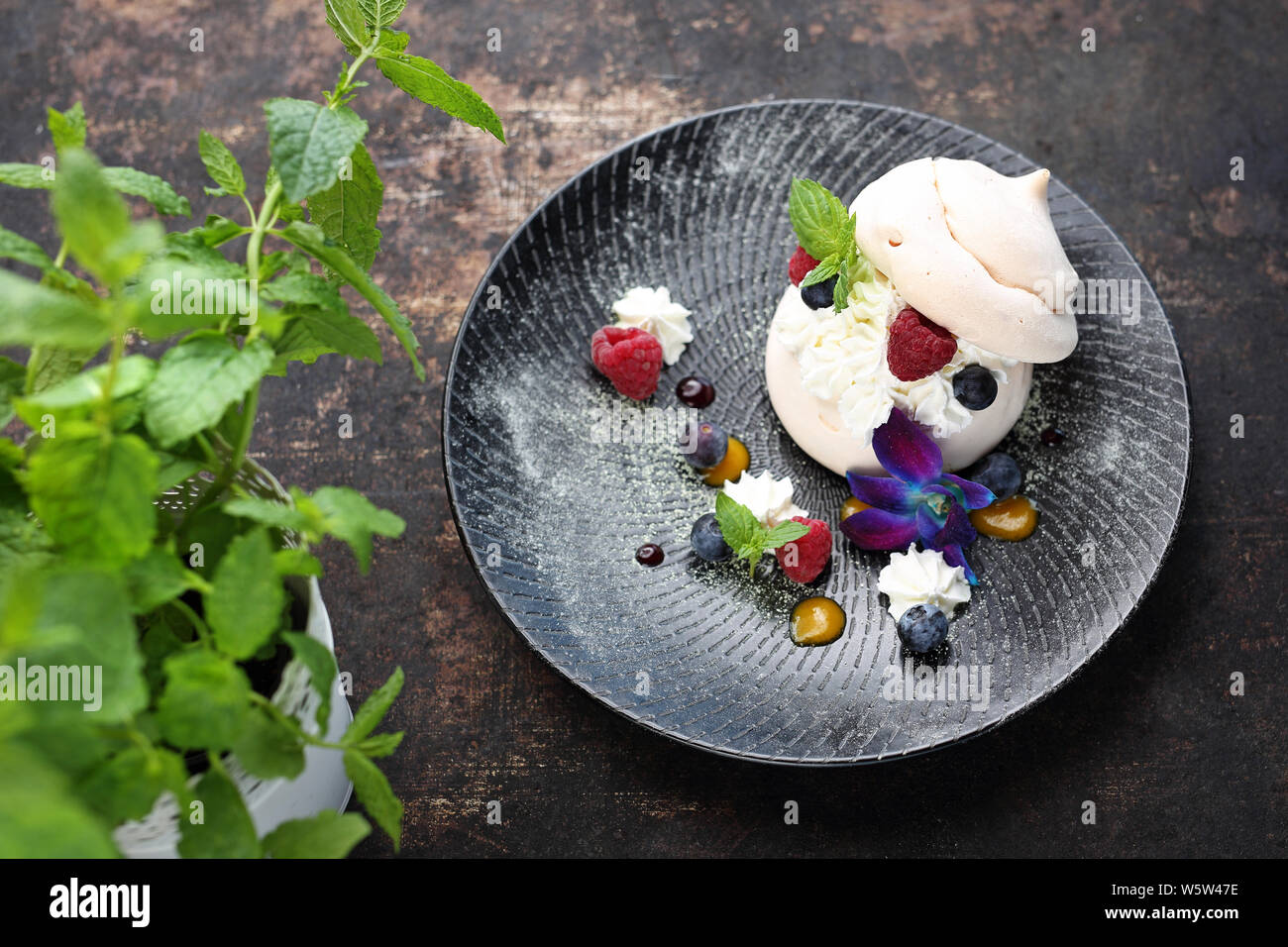 Mini meringue with whipped cream and fruit. Sweet dessert Stock Photo ...