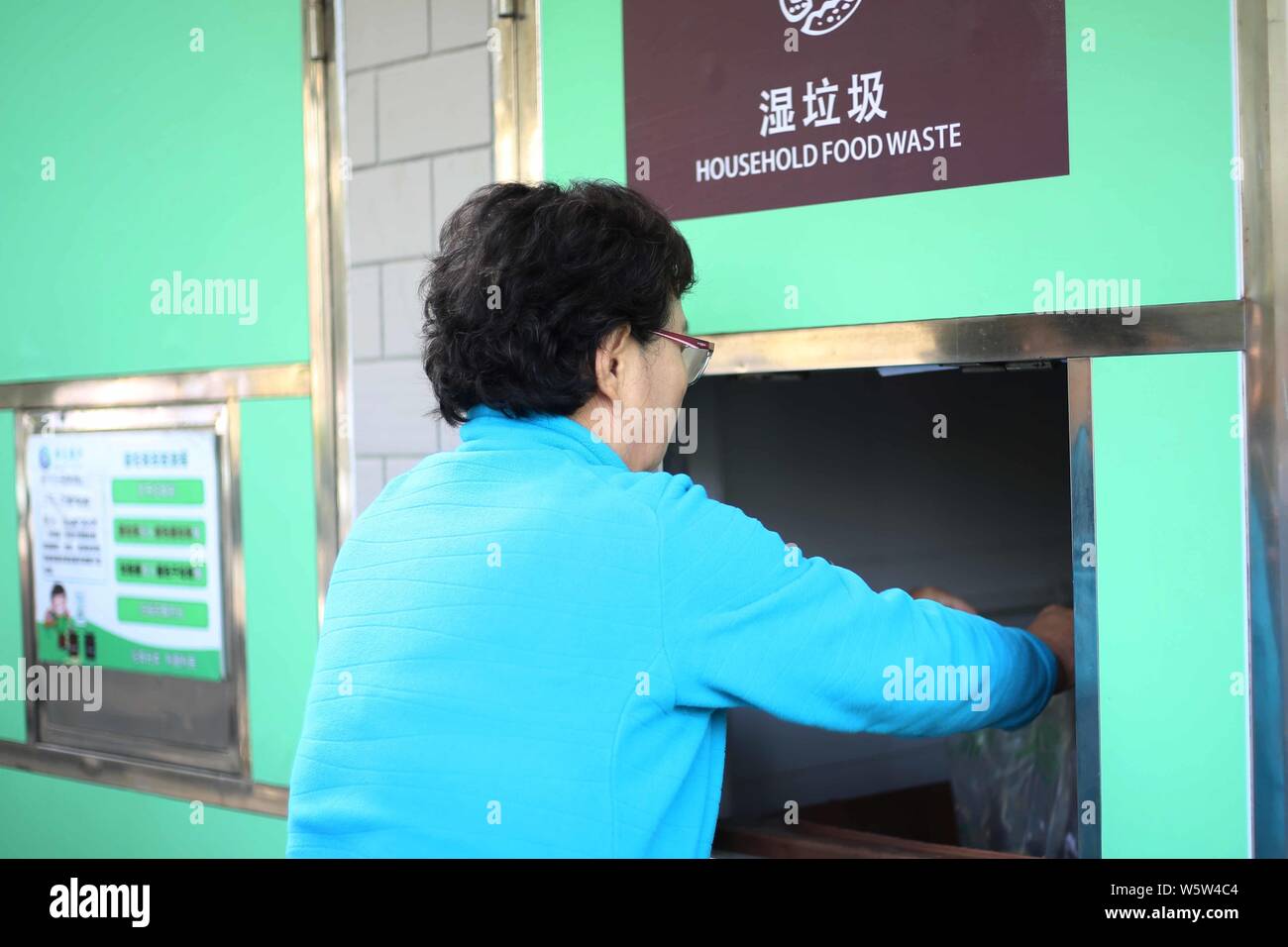 --FILE--A resident sorts his garbage and recyclables into the ...