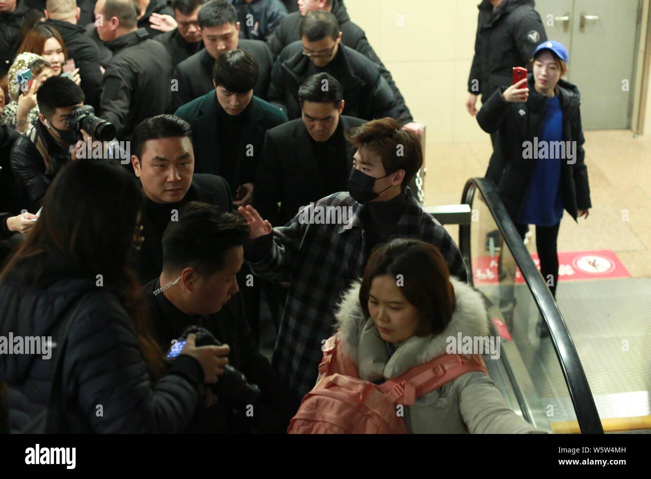 South Korean actor and model Lee Jong-suk, center, is surrounded by ...