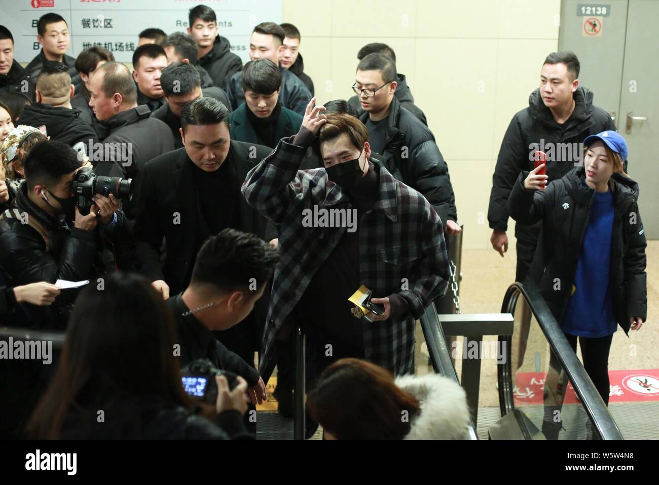 South Korean actor and model Lee Jong-suk, center, is surrounded by ...
