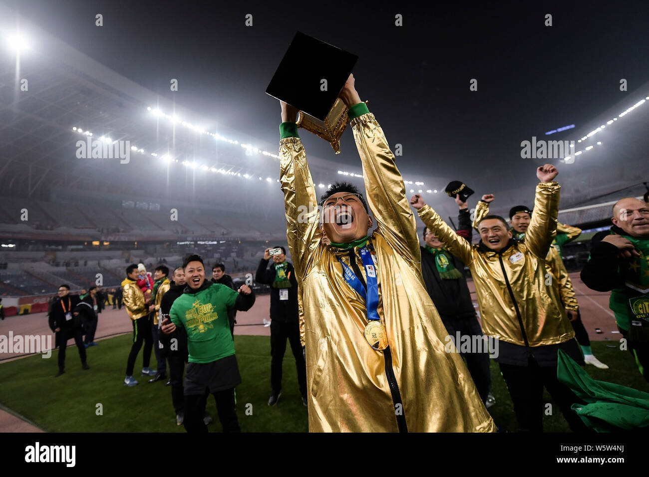 Players of Beijing Sinobo Guoan hold the trophy to celebrate after ...