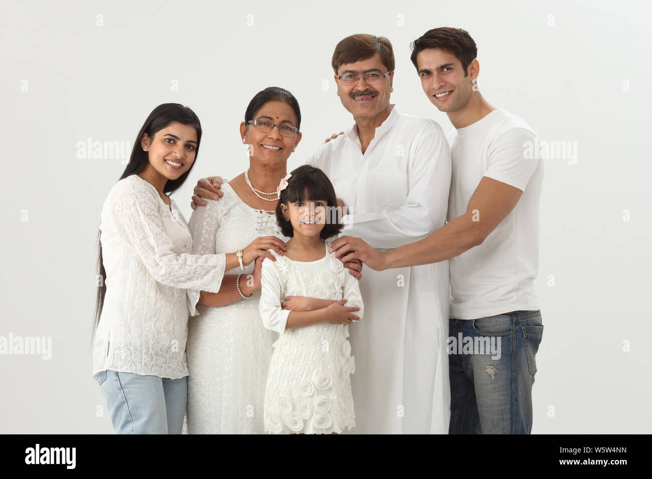 Family standing together and smiling Stock Photo - Alamy
