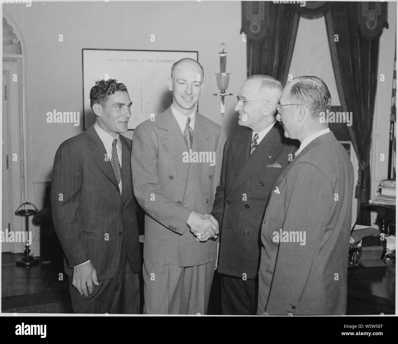 Photograph of President Truman greeting crew members from an around-the ...