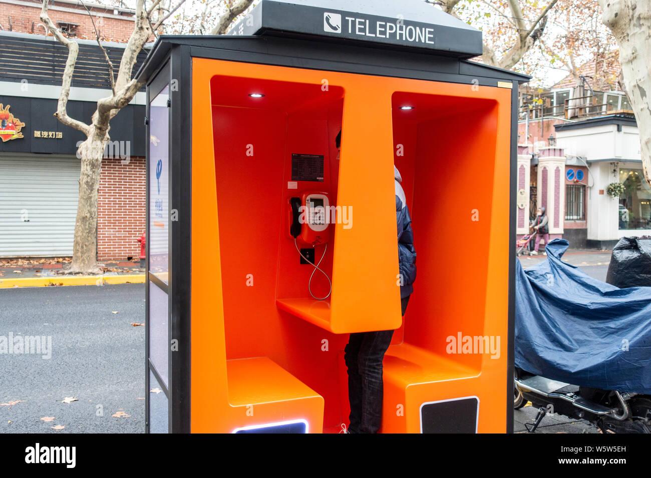 A local resident tries out a new telephone booth equipped with the ...