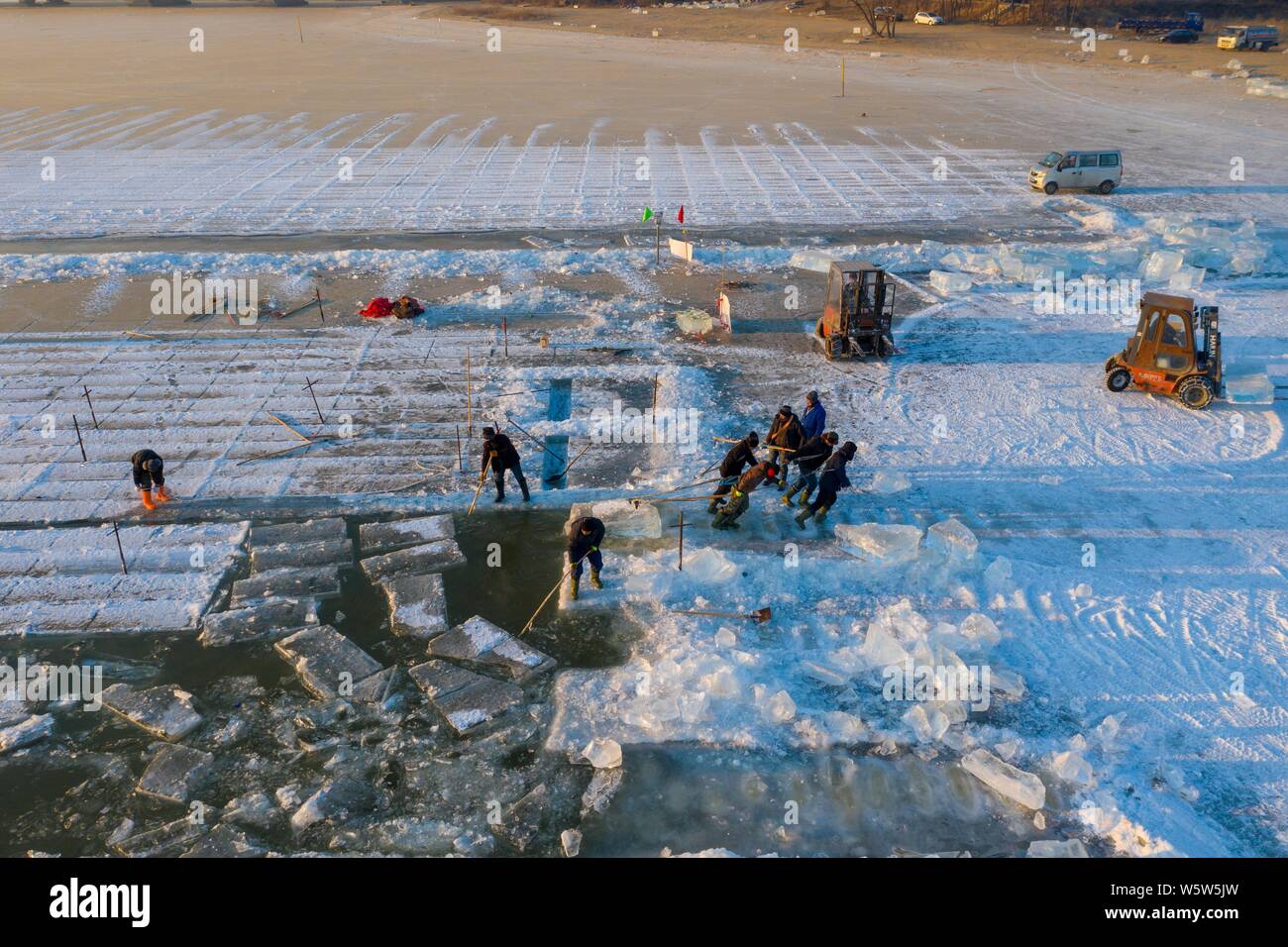 Chinese workers collect ice from the Songhua River for the upcoming ...