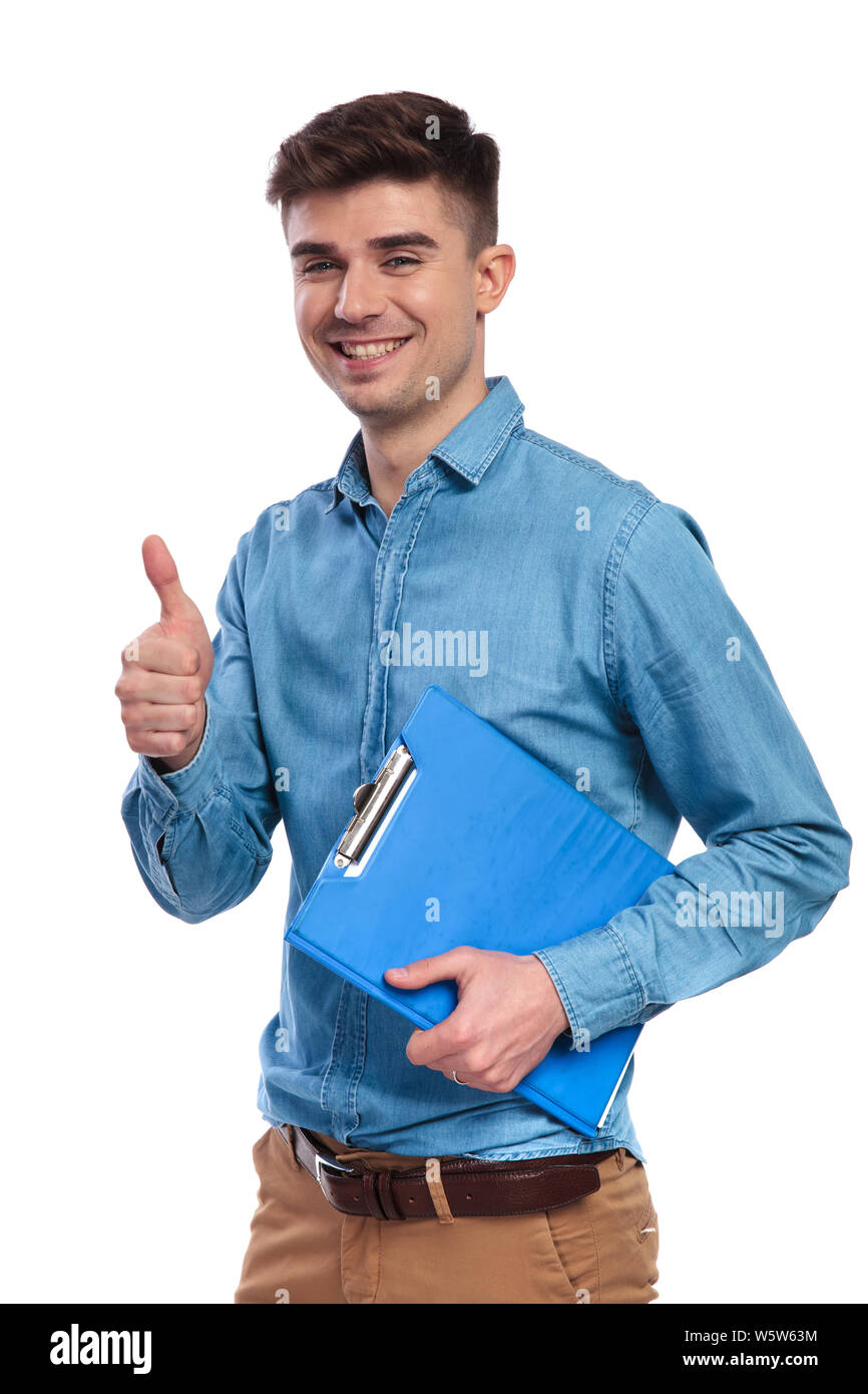 young happy student holding notepad making the ok thumbs up hand sign ...