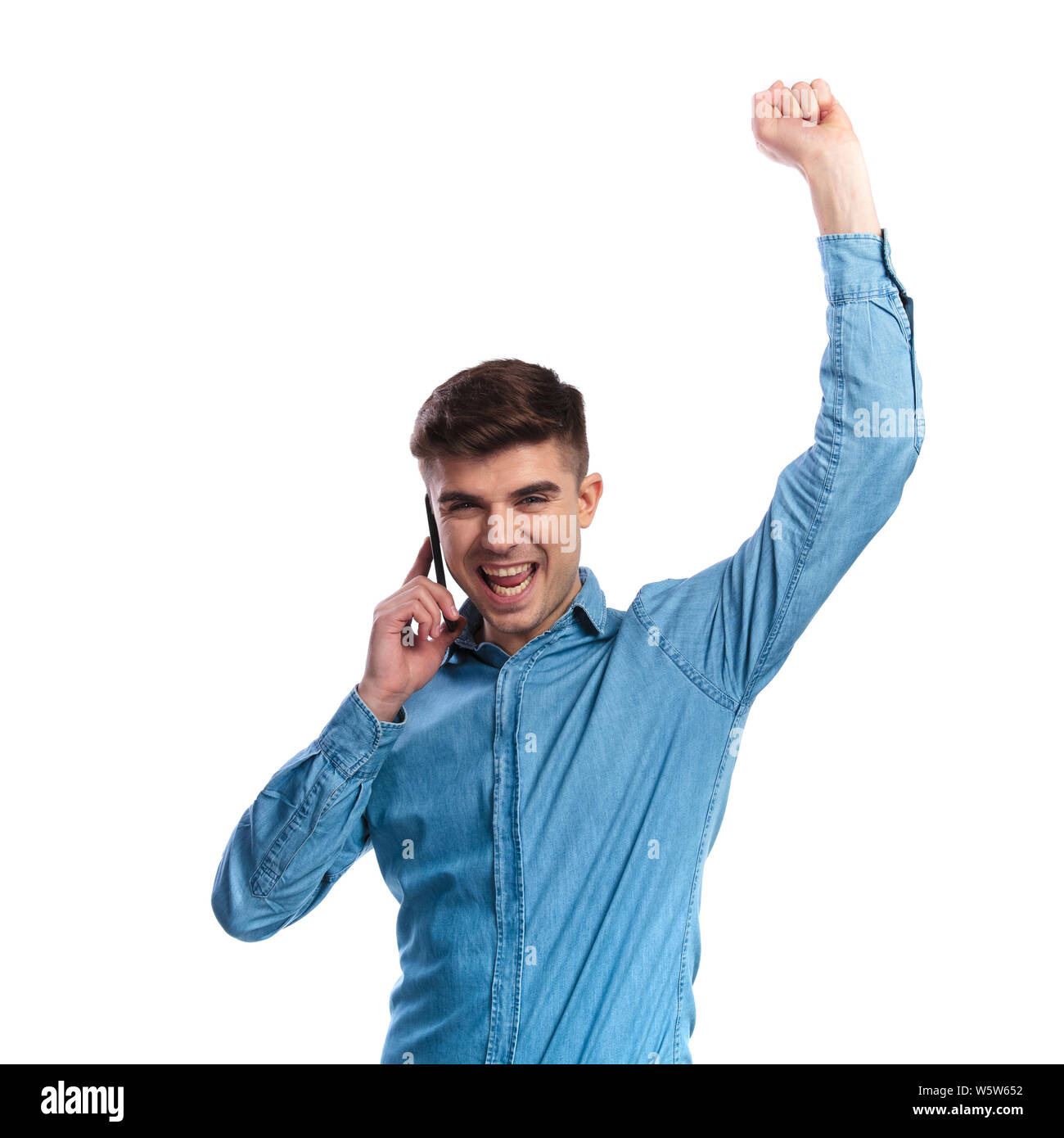 excited casual man talking on the phone is celebrating success on white ...