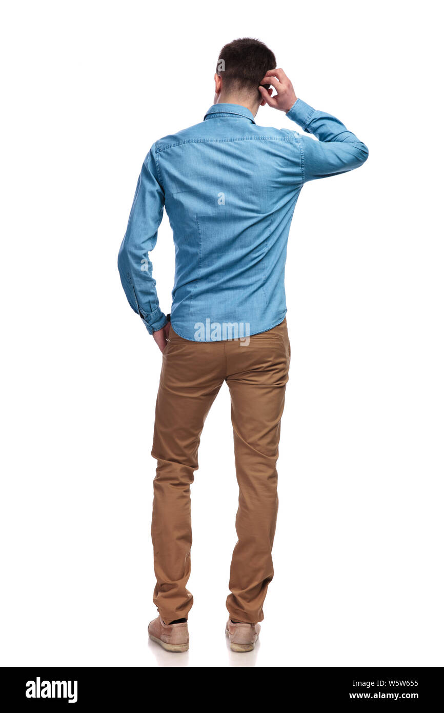 back view of a casual man scratching his head and thinking on white ...