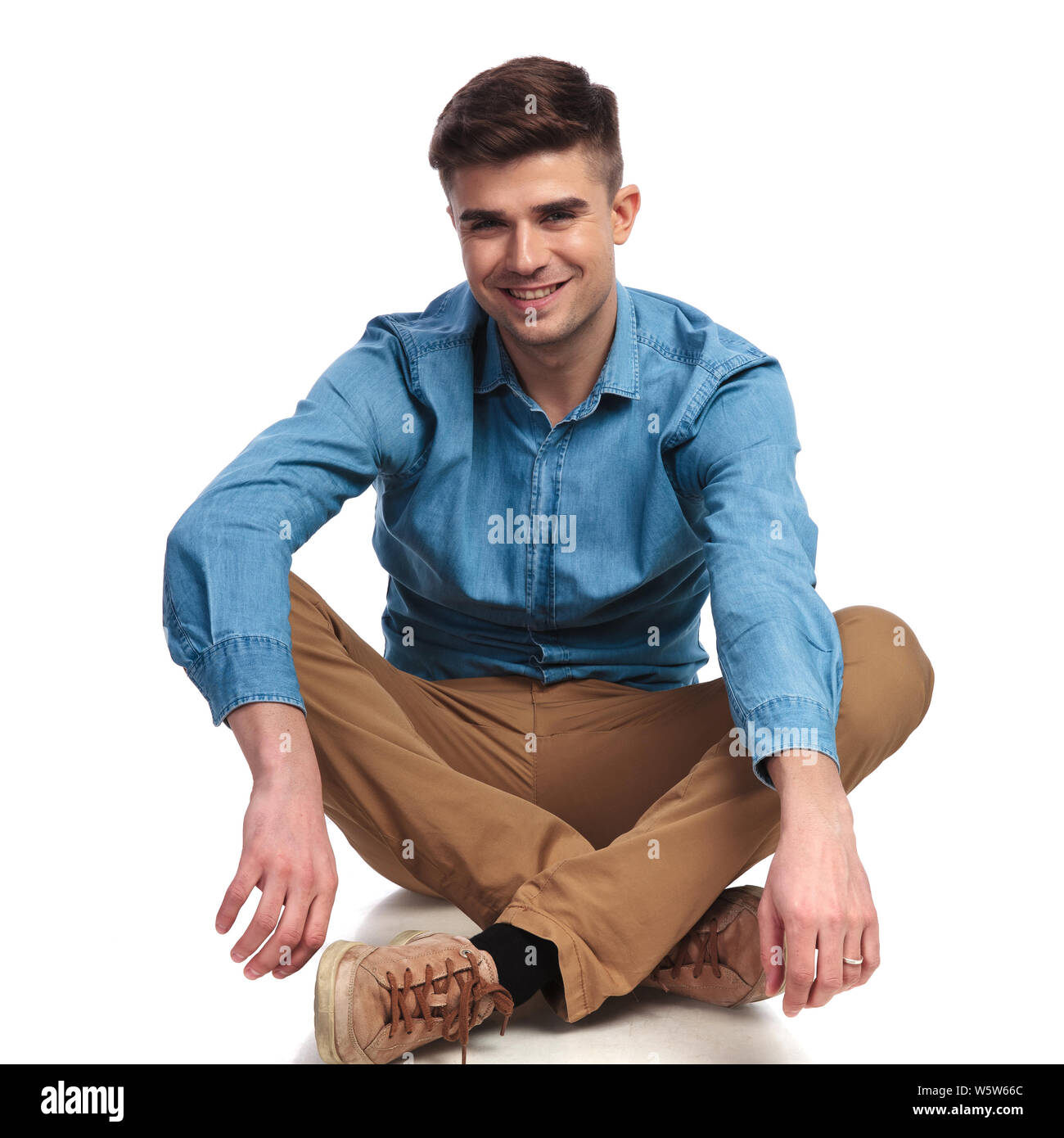 smiling casual man sitting and resting on white background Stock Photo ...