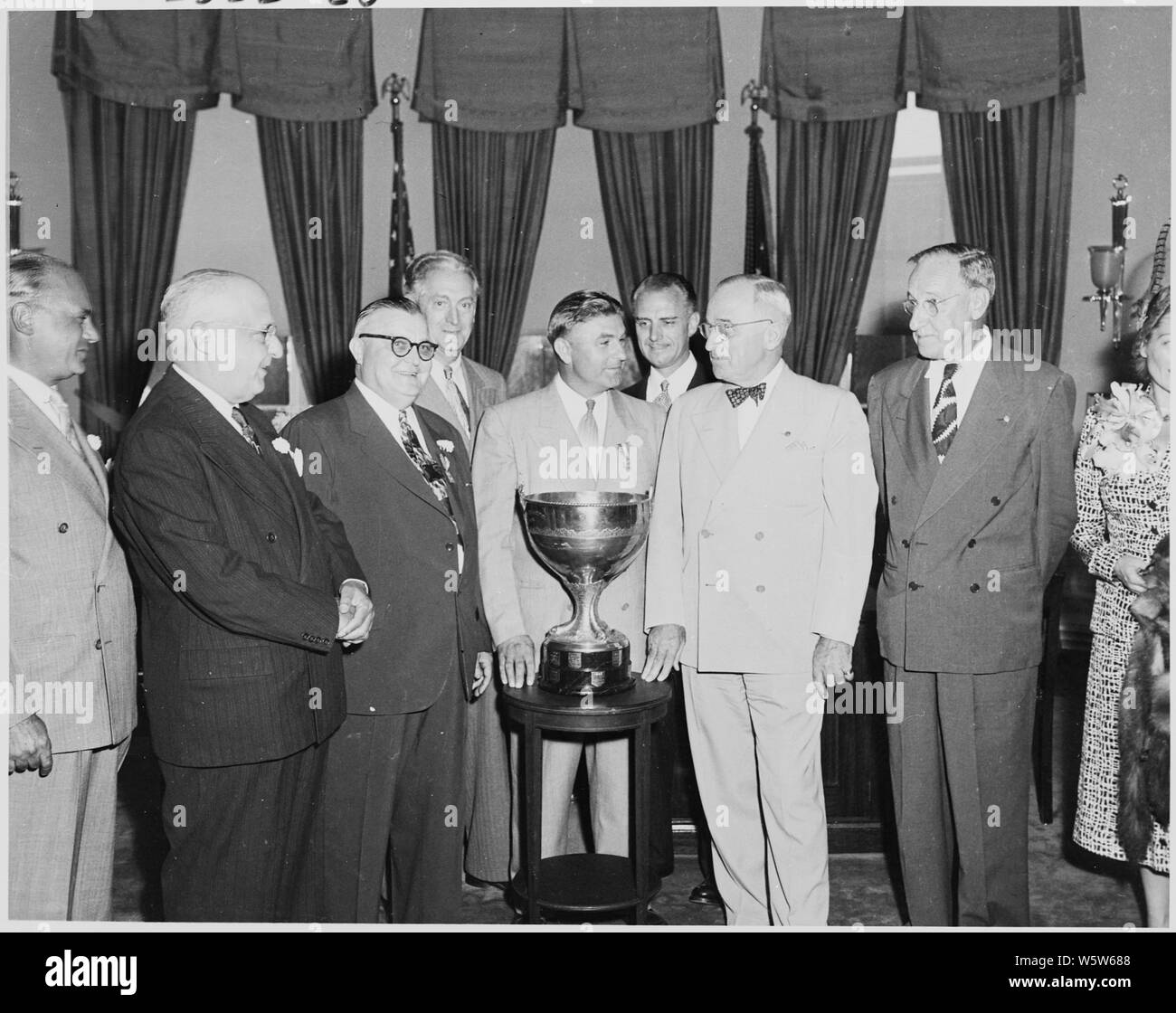 Photograph of President Truman in the Oval Office, receiving the driver ...