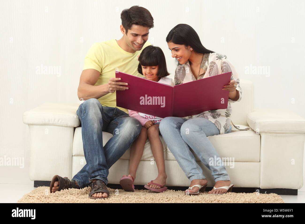 Family looking at family photo album Stock Photo - Alamy