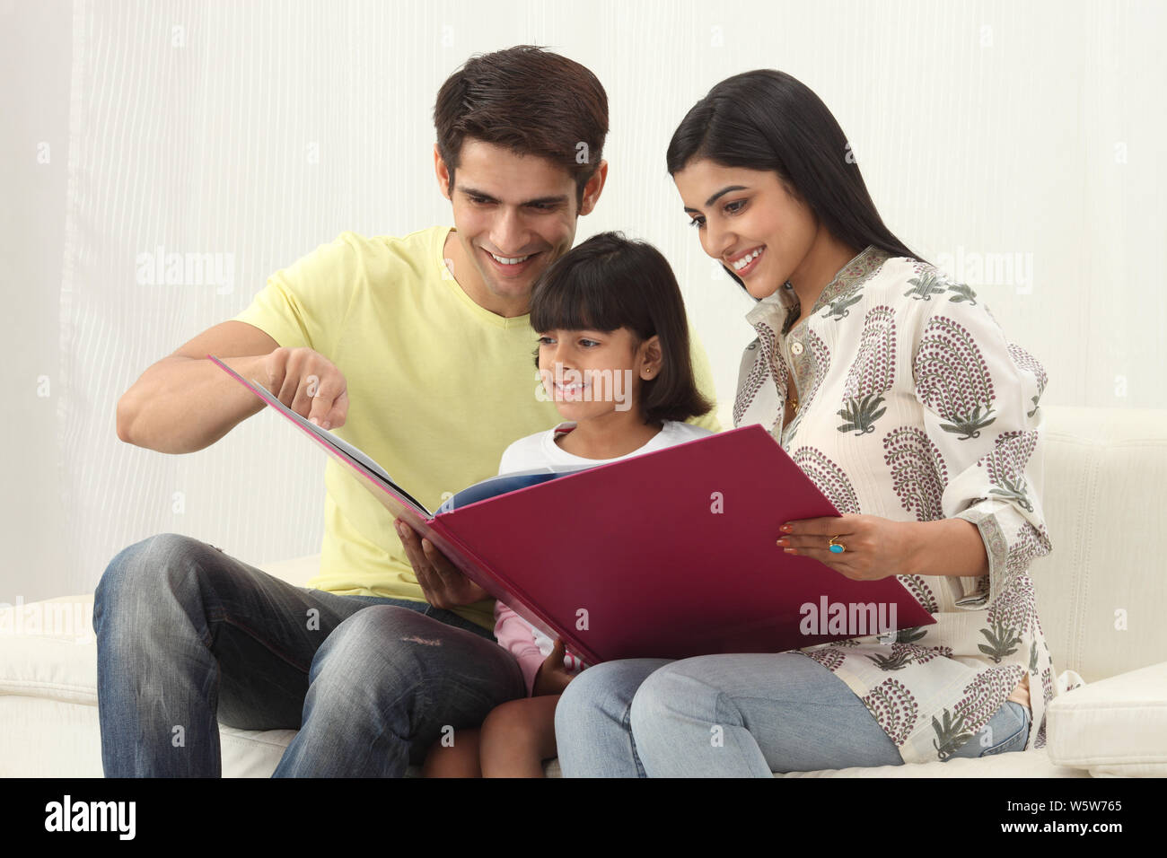 Family looking at family photo album Stock Photo - Alamy