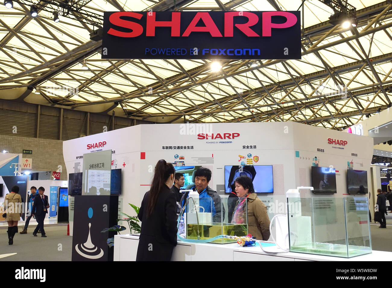 --FILE--People visit the stand of Sharp during an expo in Shanghai ...