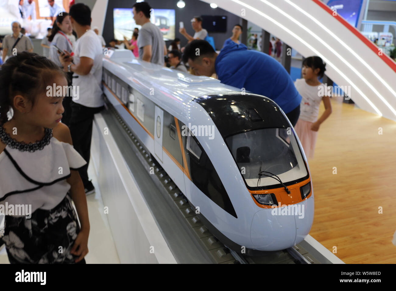 --FILE--A visitor looks at a model train on display at the stand of ...