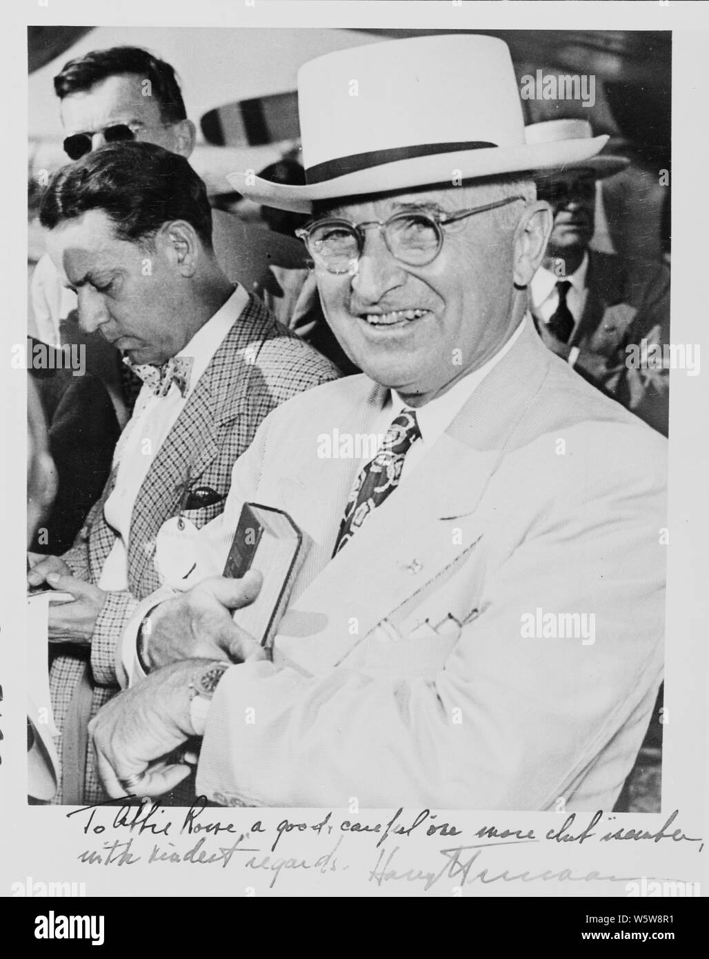 Photograph of President Truman smiling and checking his watch upon ...