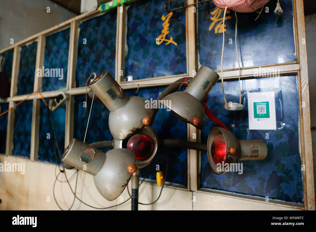 A hair curling device is pictured at the barber shop of 85-year-old ...