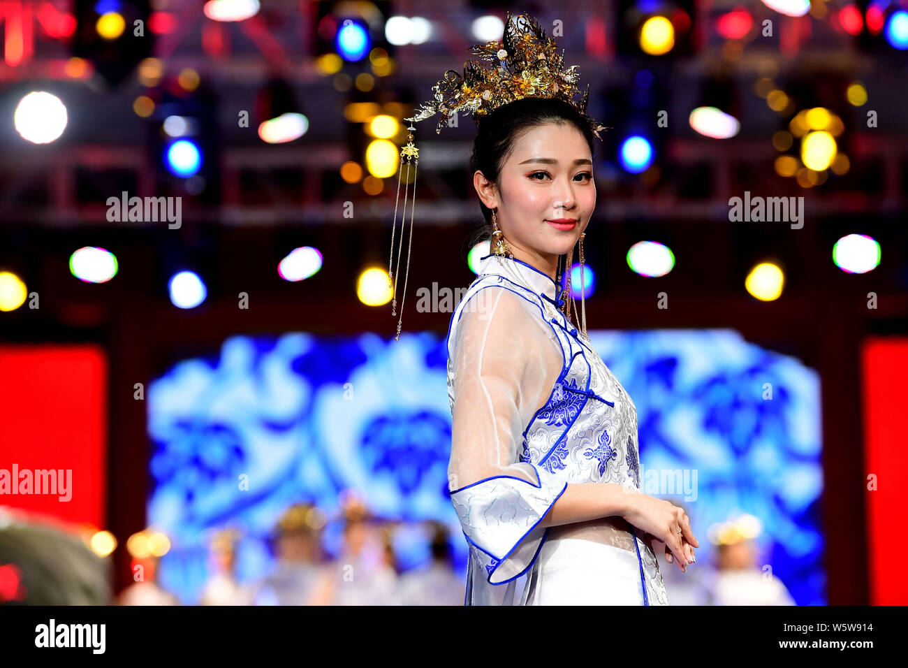 A model presents a new creation of cheongsam (qipao) made of ...