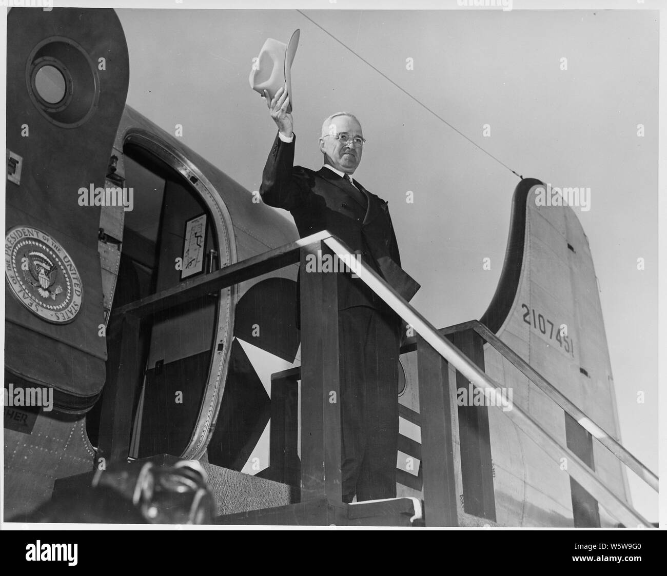 Photograph of President Truman waving goodbye as he prepares to board ...