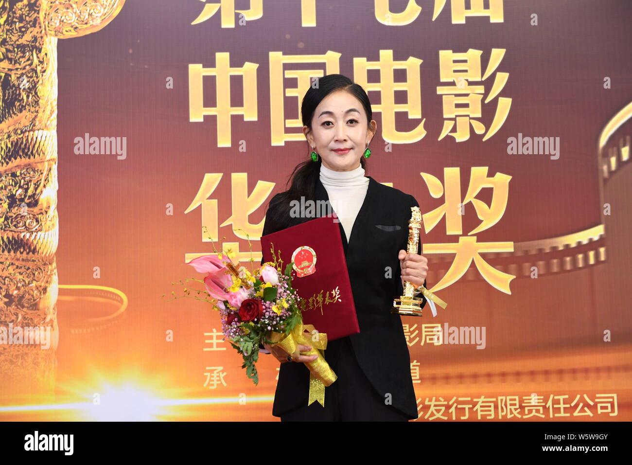 Chinese actress Chen Jin poses with her trophy after winning the Outstanding Actress award at ...