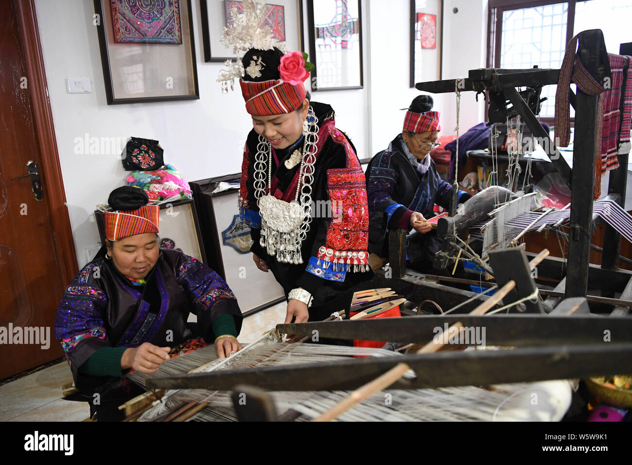 Chinese woman Liu Ying of Miao ethnic group instructs a craftswoman to ...