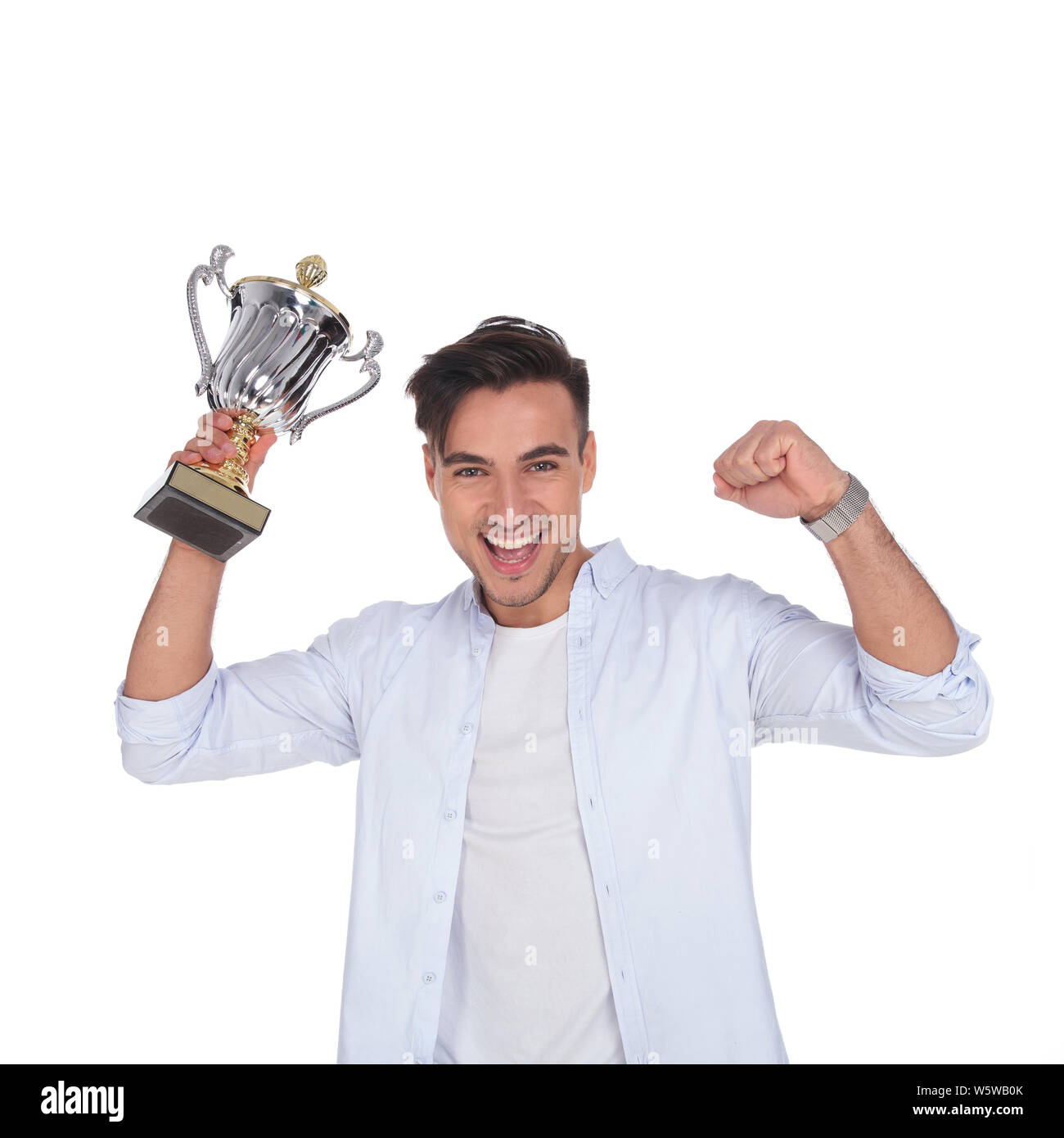 excited young casual man with trophy cup award is celebrating success ...