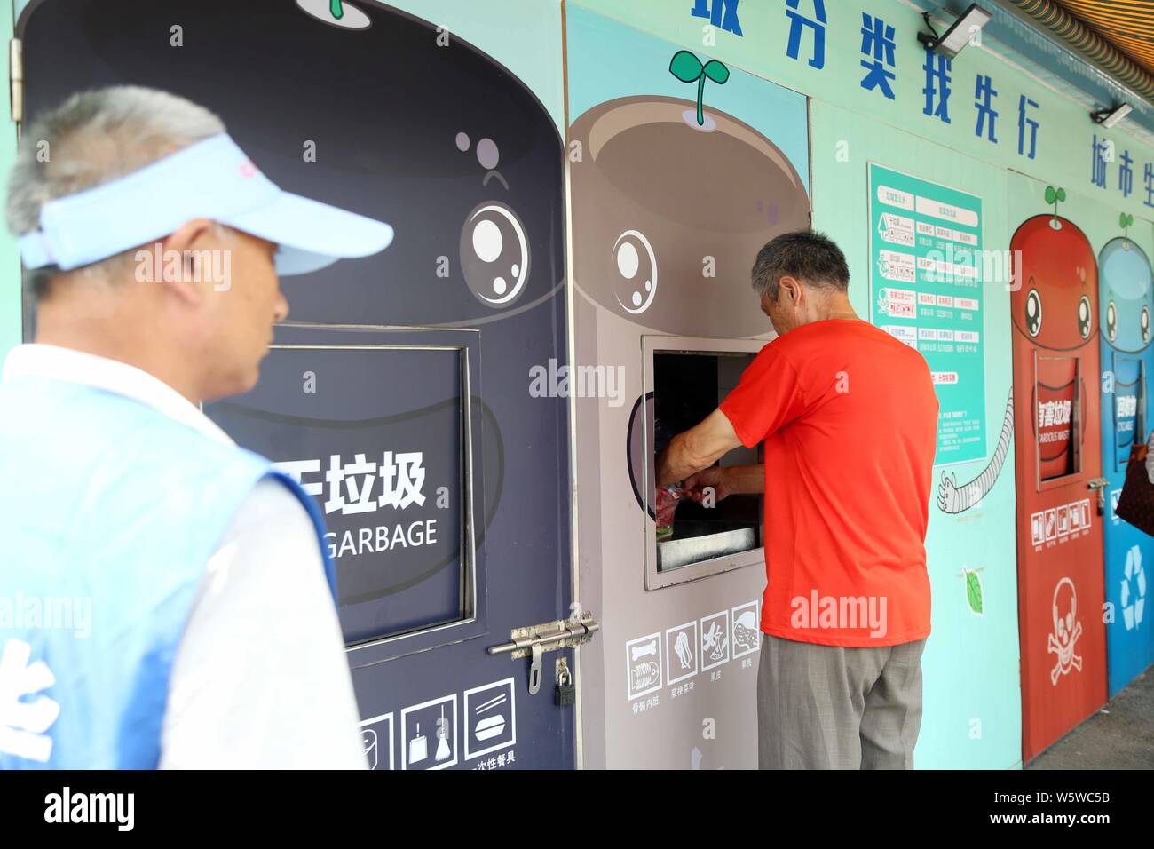 --FILE--Residents sort their garbage and recyclables into the ...