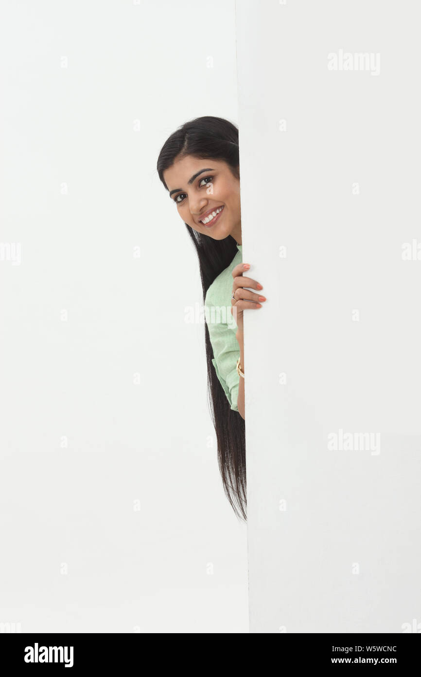 Woman hiding behind wall a watching hi-res stock photography and images ...